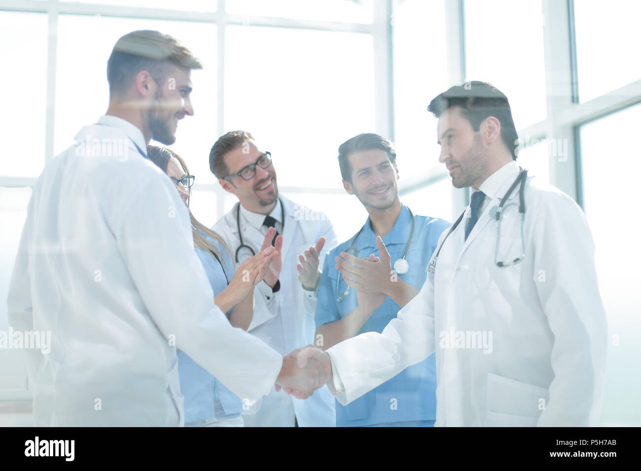 Doctors partners shaking hands hi-res stock photography and images - Alamy
