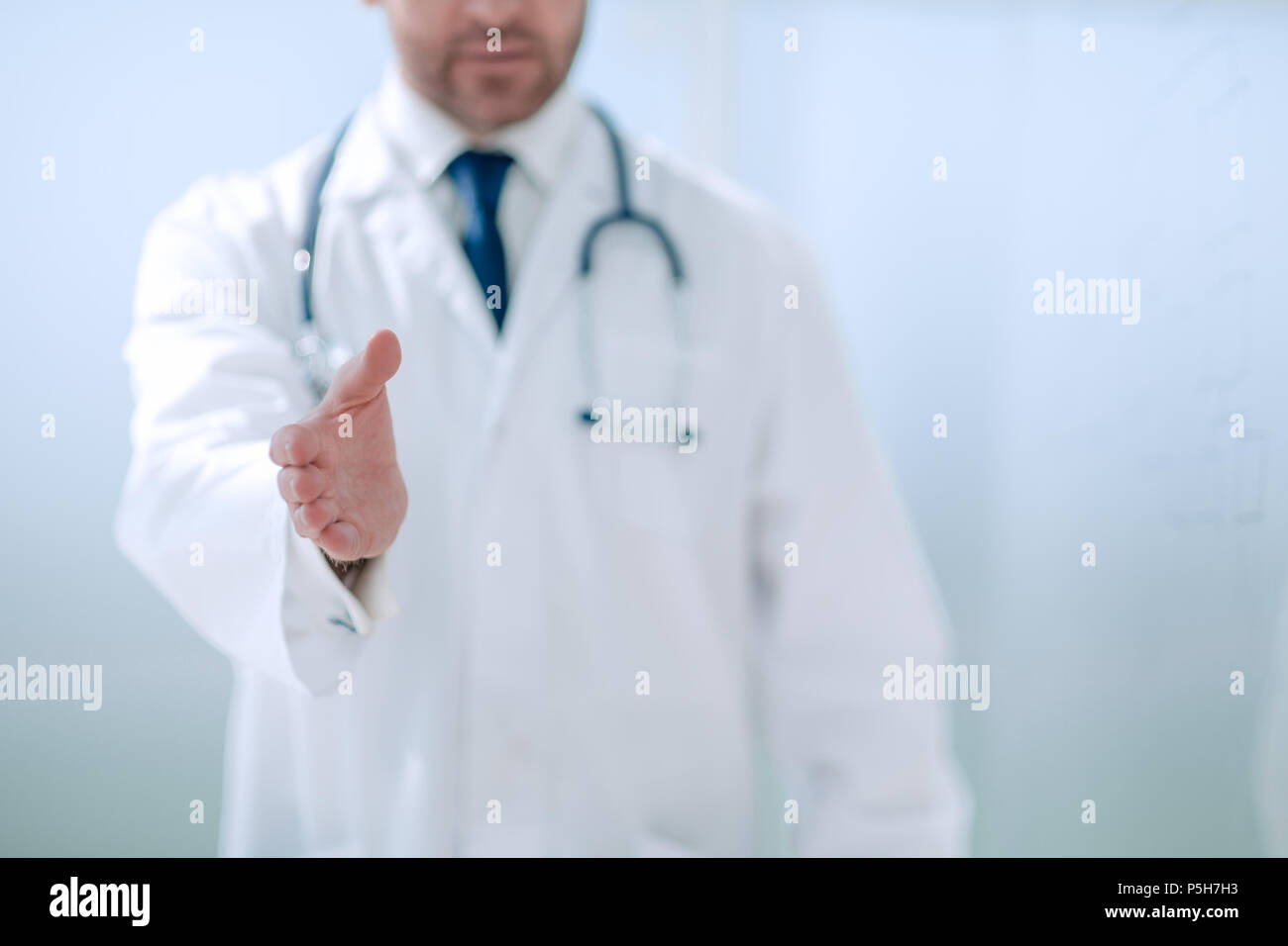 background image of the doctor holding out his hand for greeting Stock ...