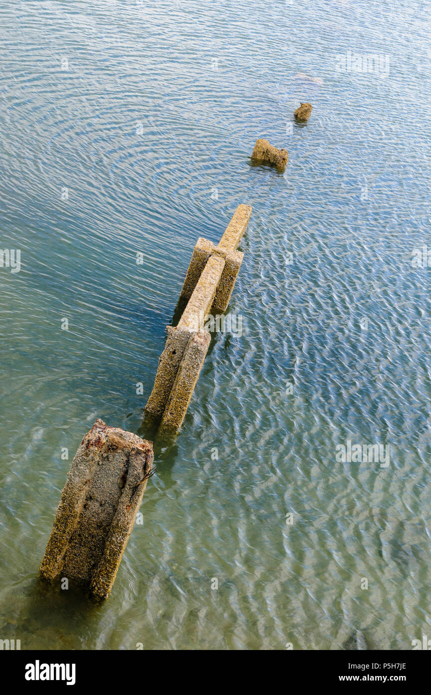 Broken, semi-submerged tidal defences, built in the 1920s to prevent ...