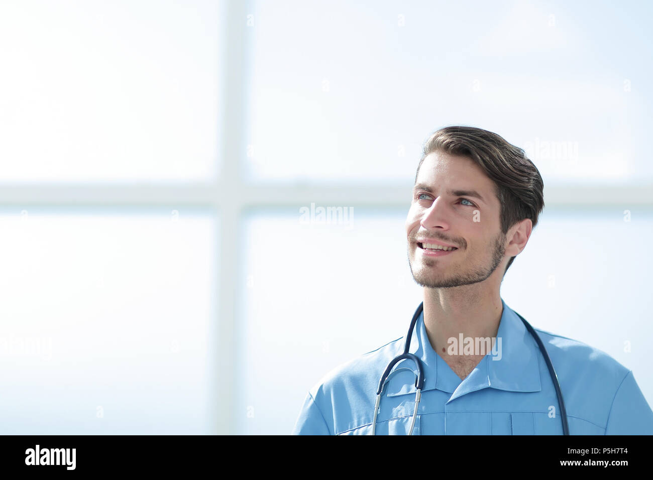 portrait of a friendly doctor in blue uniform Stock Photo - Alamy