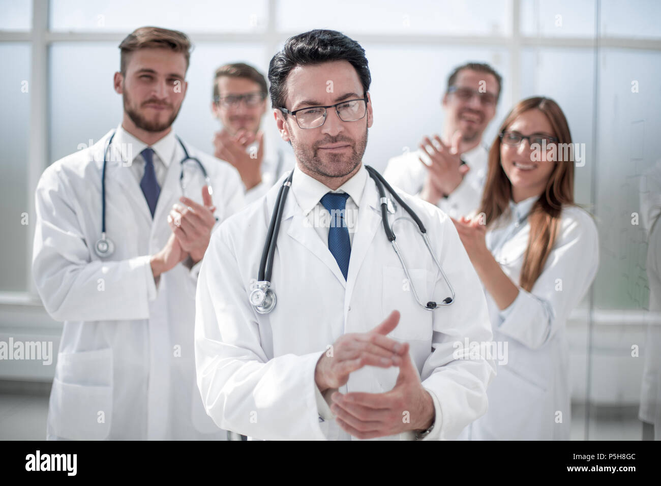 successful doctor, accepting congratulations from colleagues Stock ...