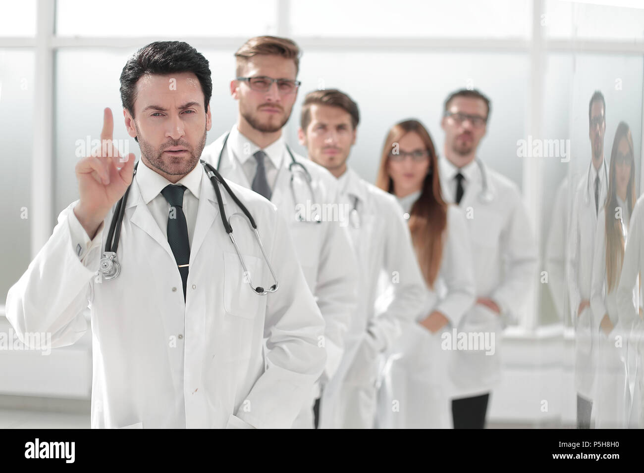 doctor lifting his index finger up Stock Photo - Alamy