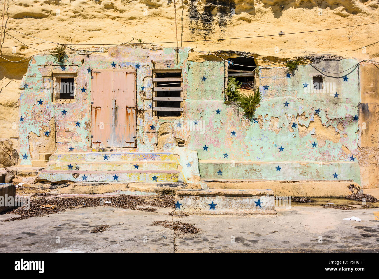 An old, traditional building carved into limestone, and decorated with ...