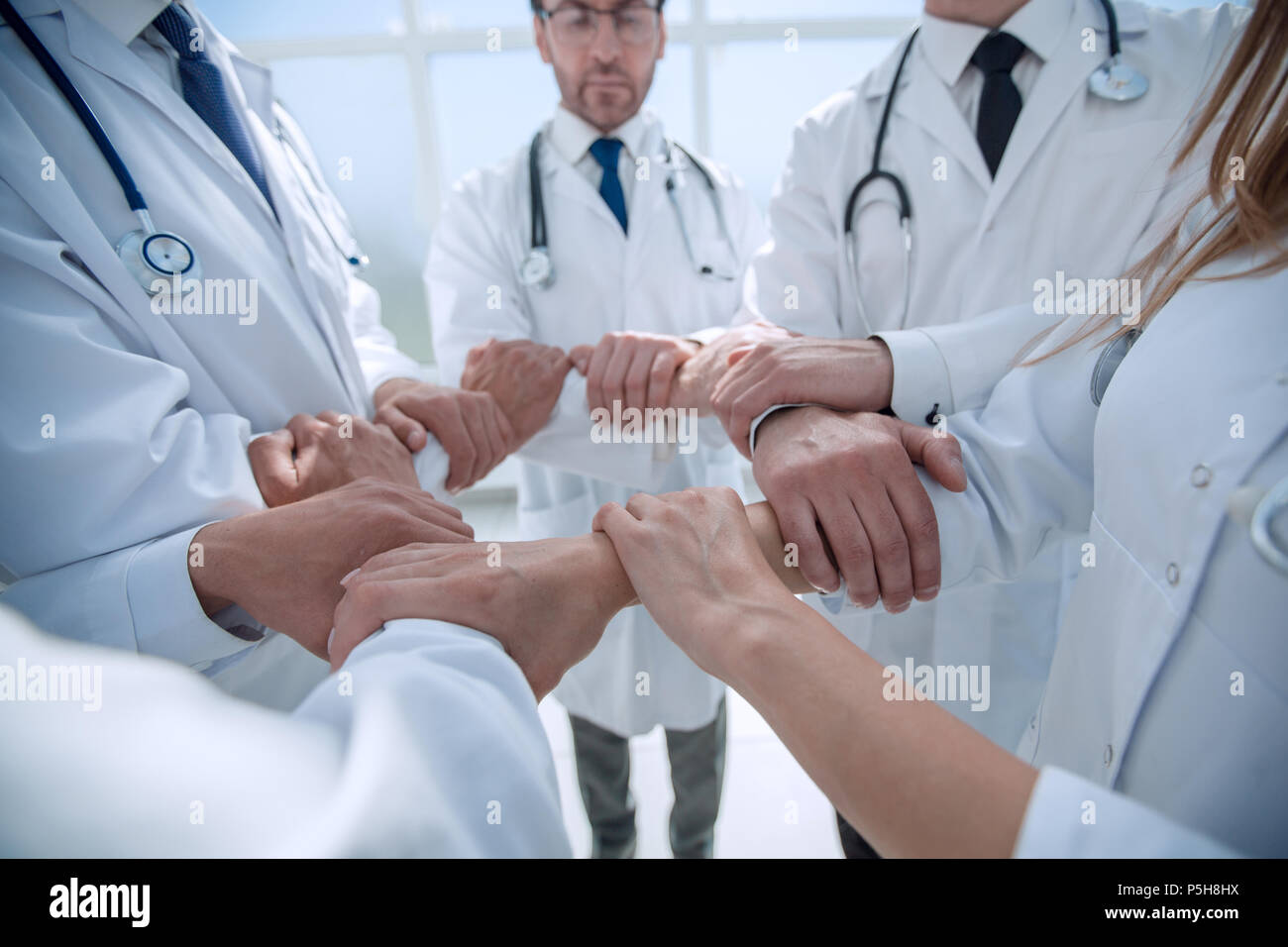 close up.a group of doctors standing in a circle Stock Photo - Alamy