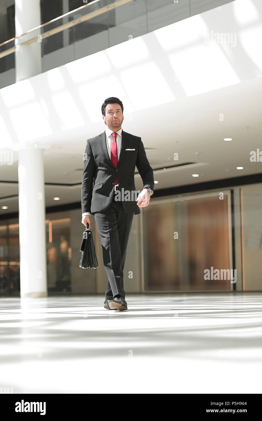 Young businessman leaving business center hi-res stock photography and ...