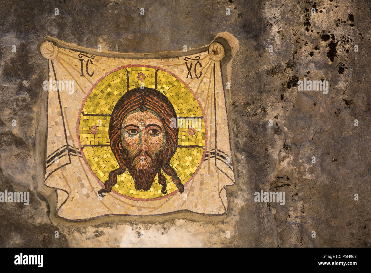 Mosaic artwork of head of Jesus Christ with golden halo and blanket on ...