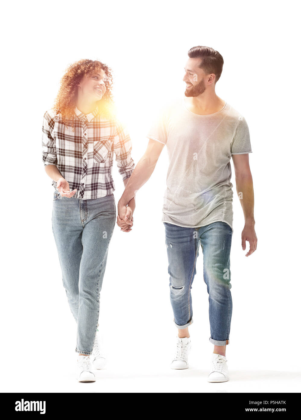 young people holding hands and walking forward Stock Photo - Alamy