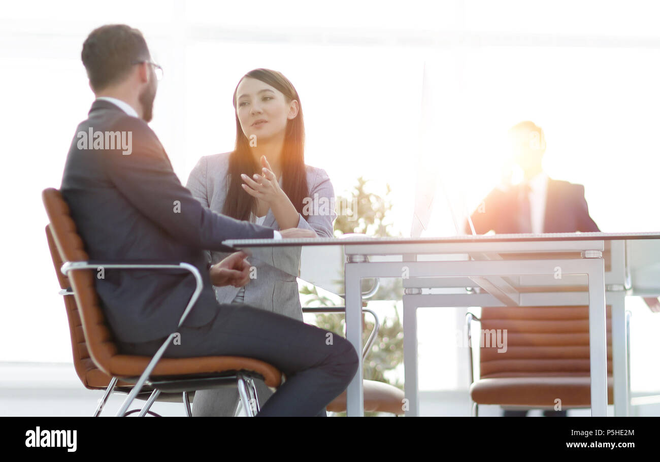 business colleagues talking, sitting behind a Desk Stock Photo - Alamy