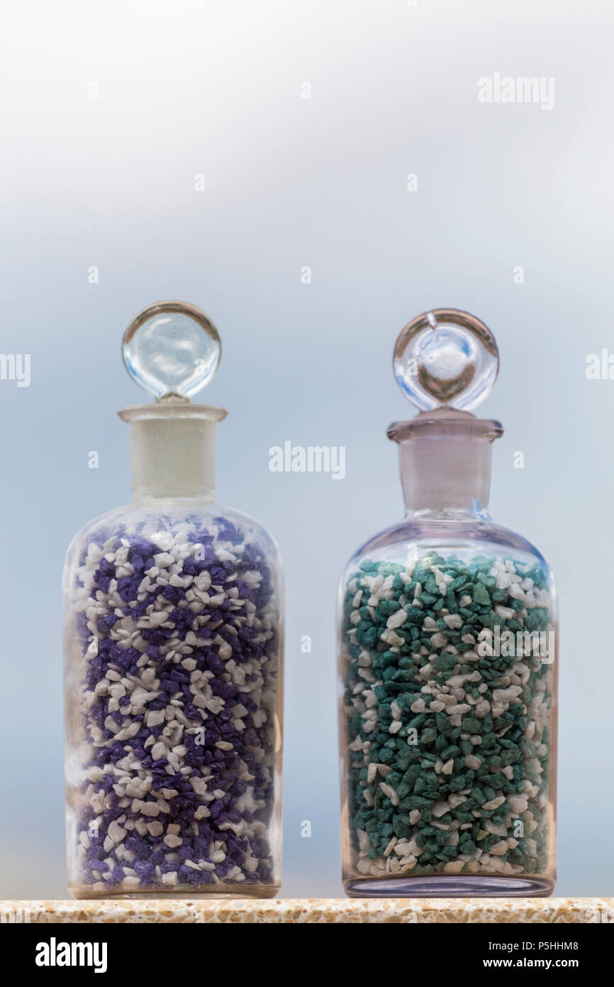 glass bottles with colored stones Stock Photo - Alamy