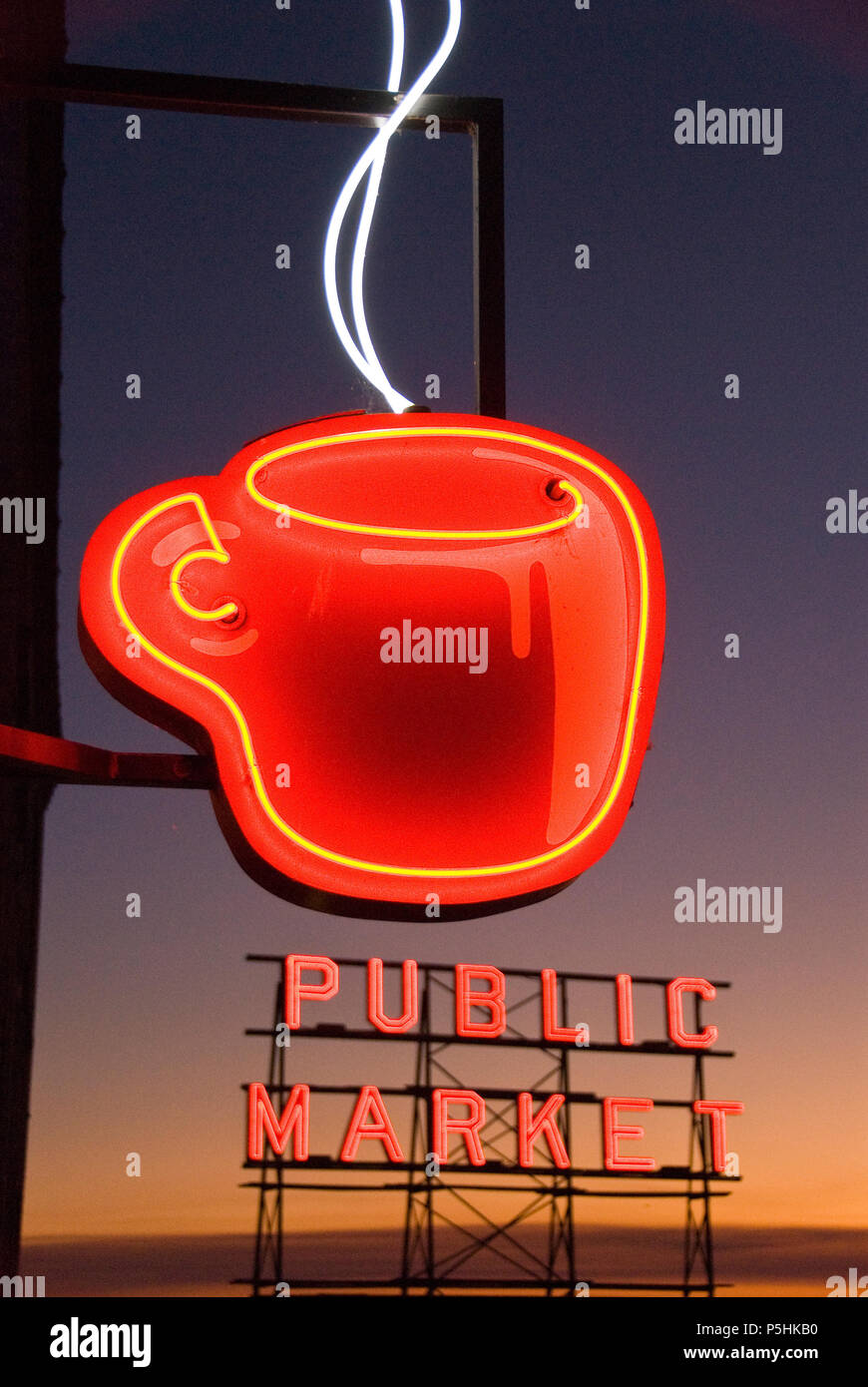 A neon coffee cup sign and neon Public Market sign at sunset, Seattle ...