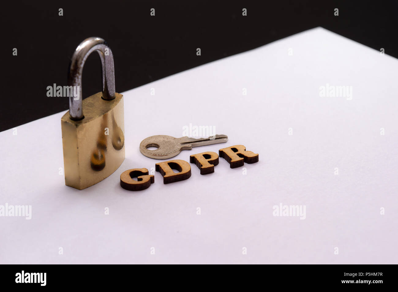 GDPR letters next to a lock and key over a white paper Stock Photo - Alamy