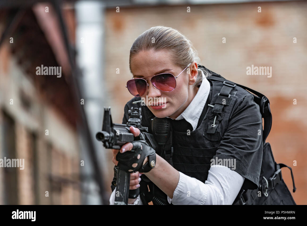 Powerful Woman Holding Gun. War Action Movie Style Stock Photo - Alamy