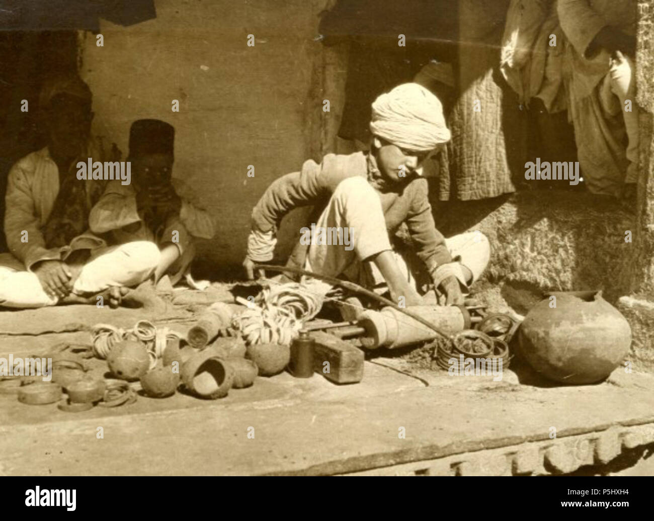 N/A. English: A boy making bangles from coconut shells at a Bangle ...