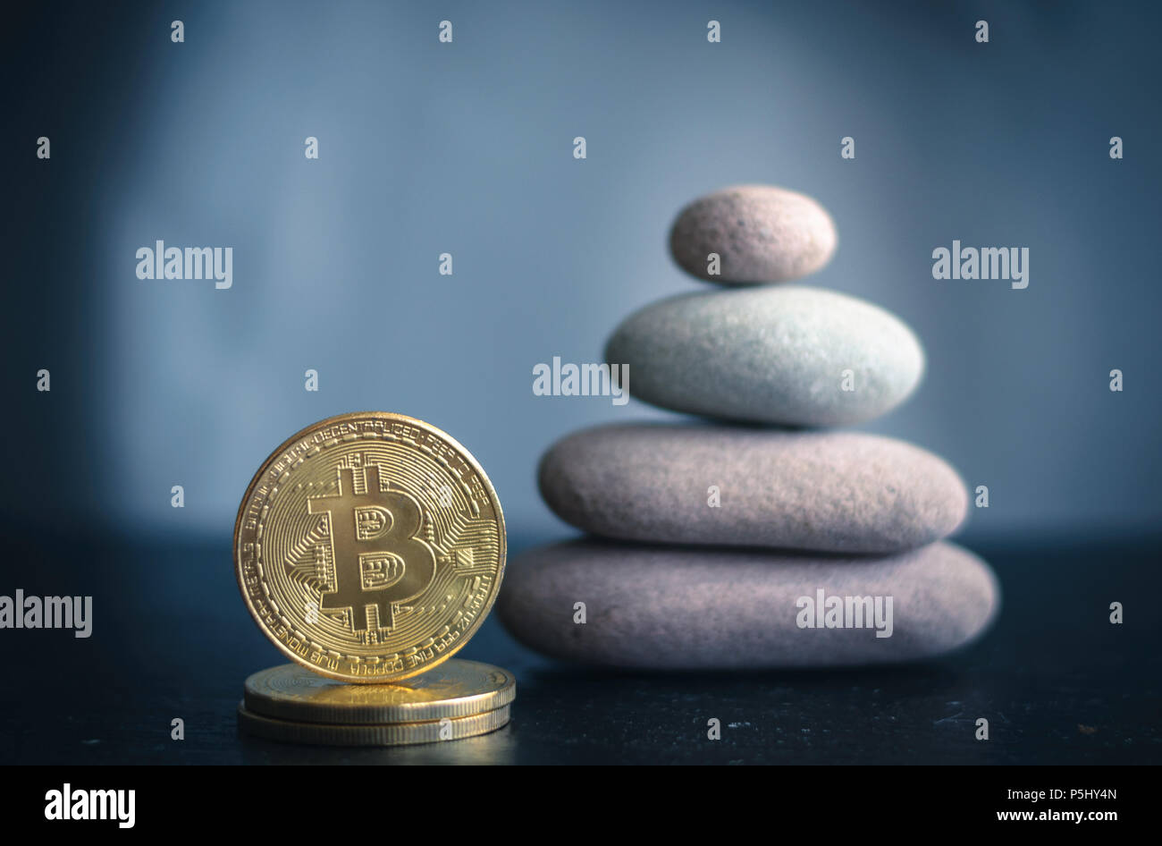 Golden bitcoin coin on the background of the pyramid of stones is a ...