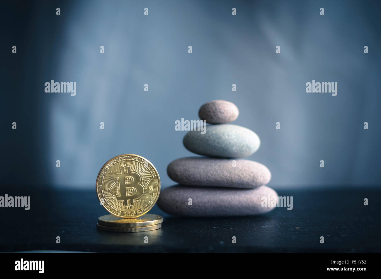 Golden bitcoin coin on the background of the pyramid of stones is a ...