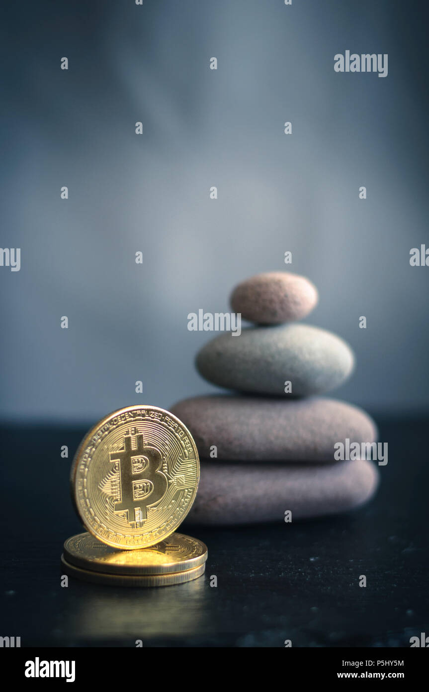 Golden bitcoin coin on the background of the pyramid of stones is a ...