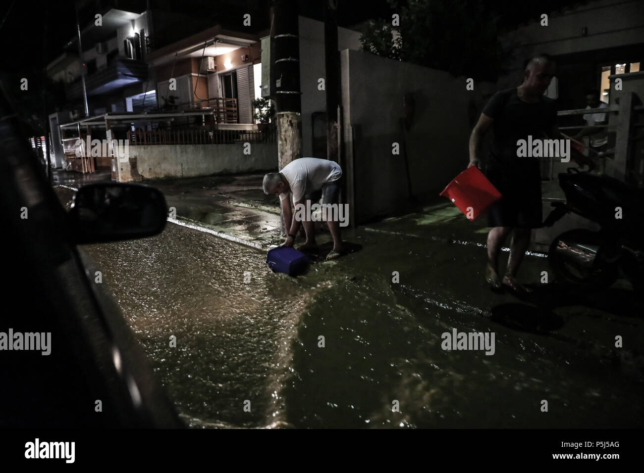 Athens, Greece. 26th June, 2018. Local residents clean mud out of their ...