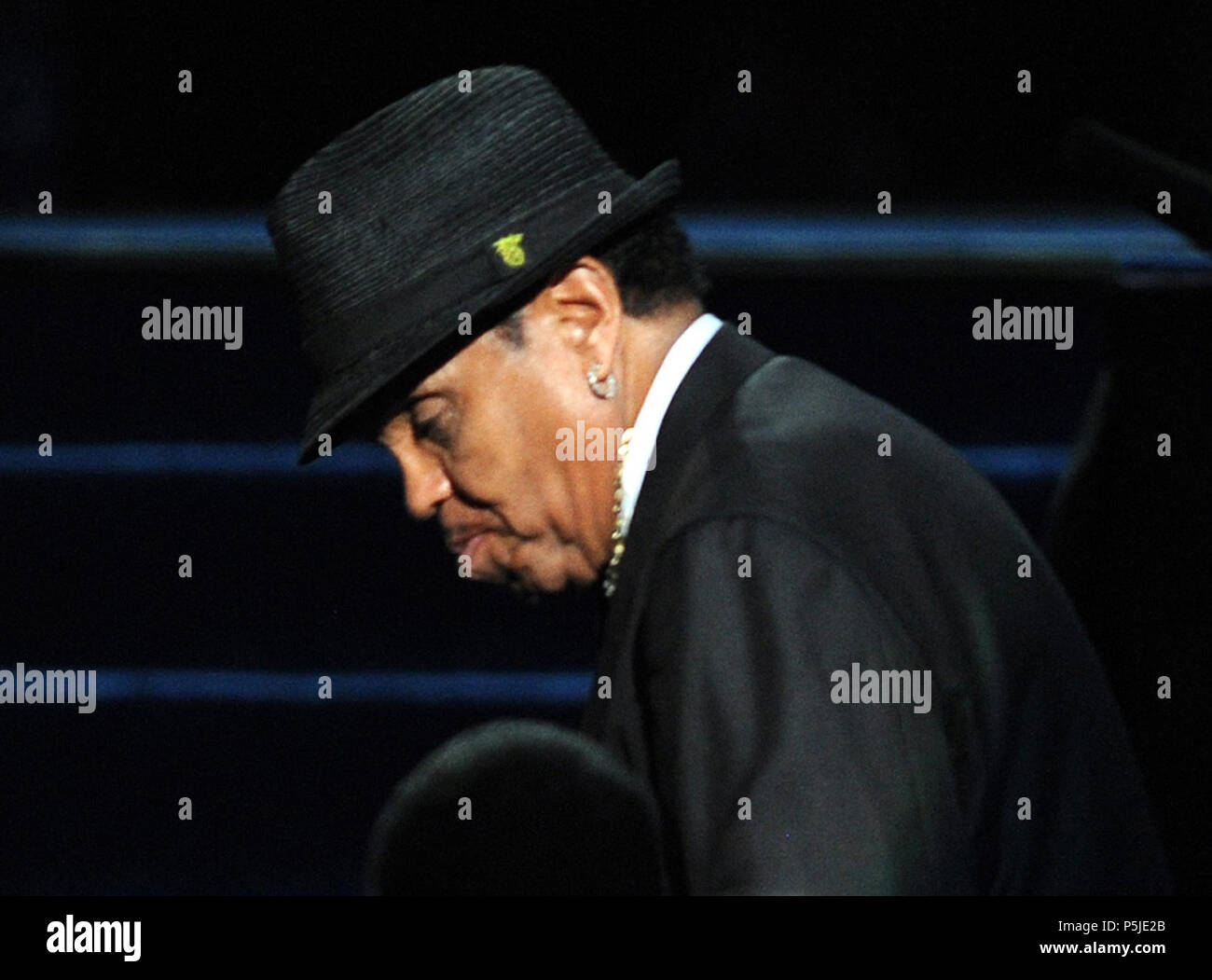 Joe Jackson returns to his seat at the memorial service for his son ...