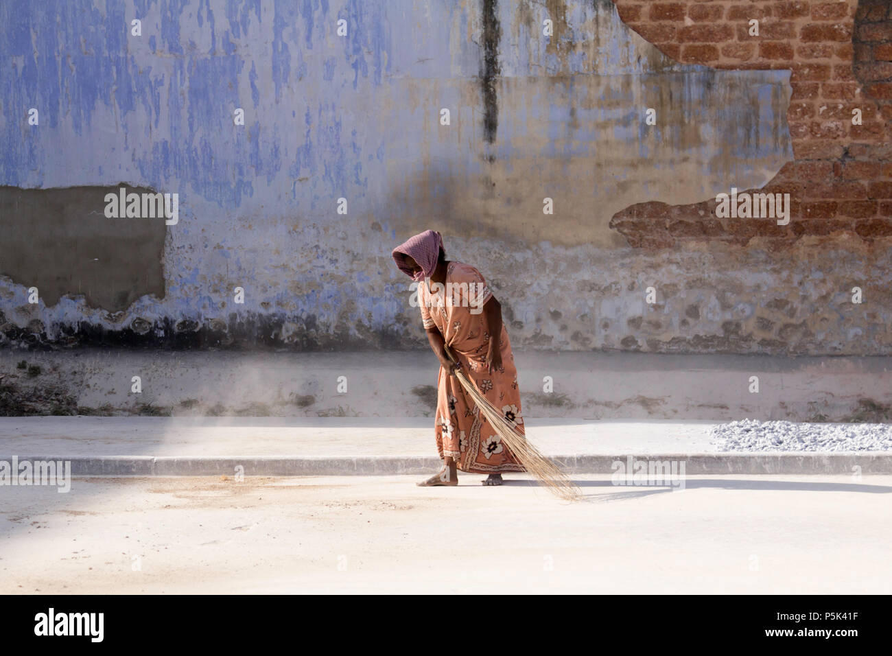 Old woman sweeping street hi-res stock photography and images - Alamy