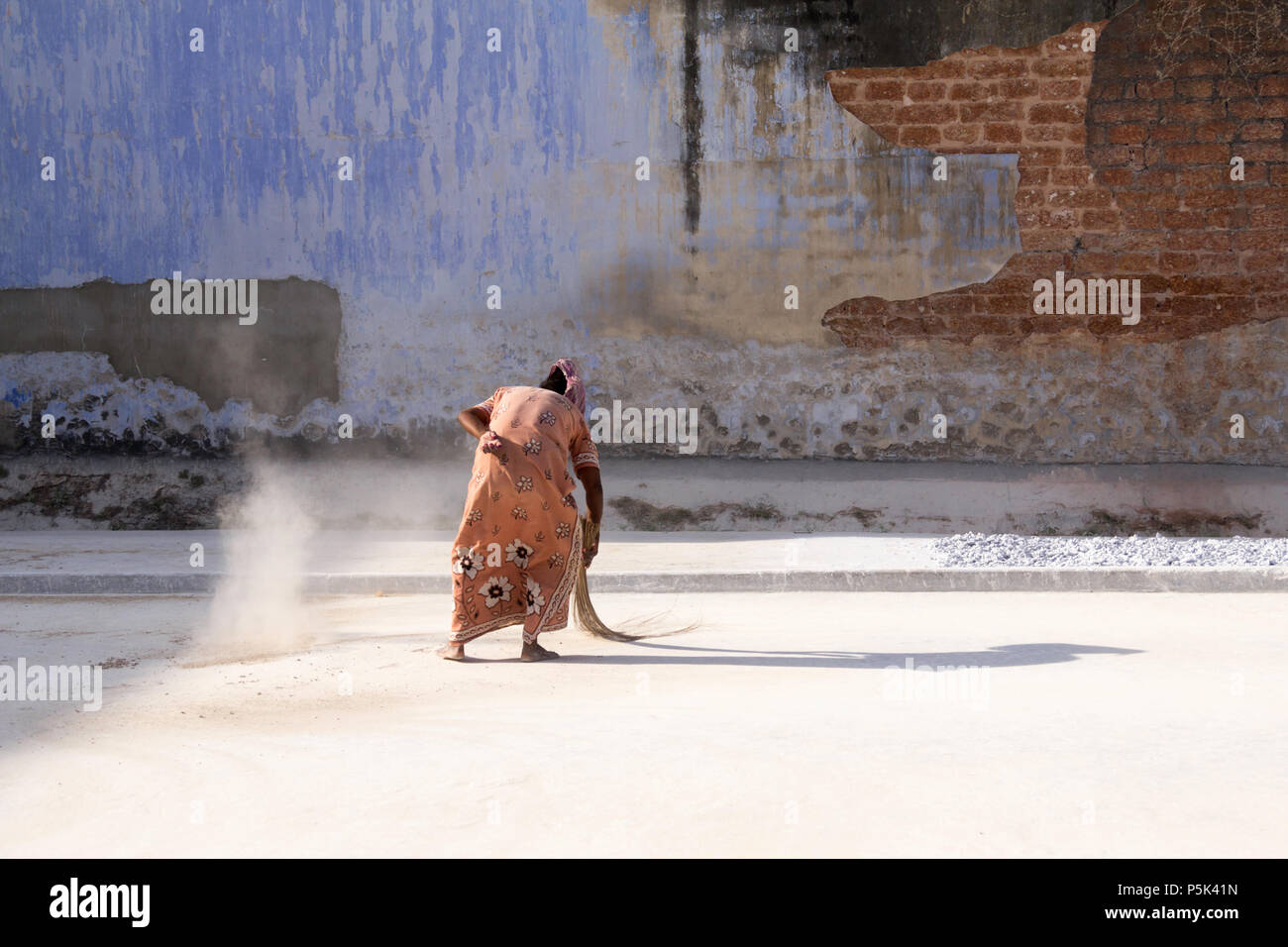 Indian woman sweeping broom in hi-res stock photography and images - Alamy