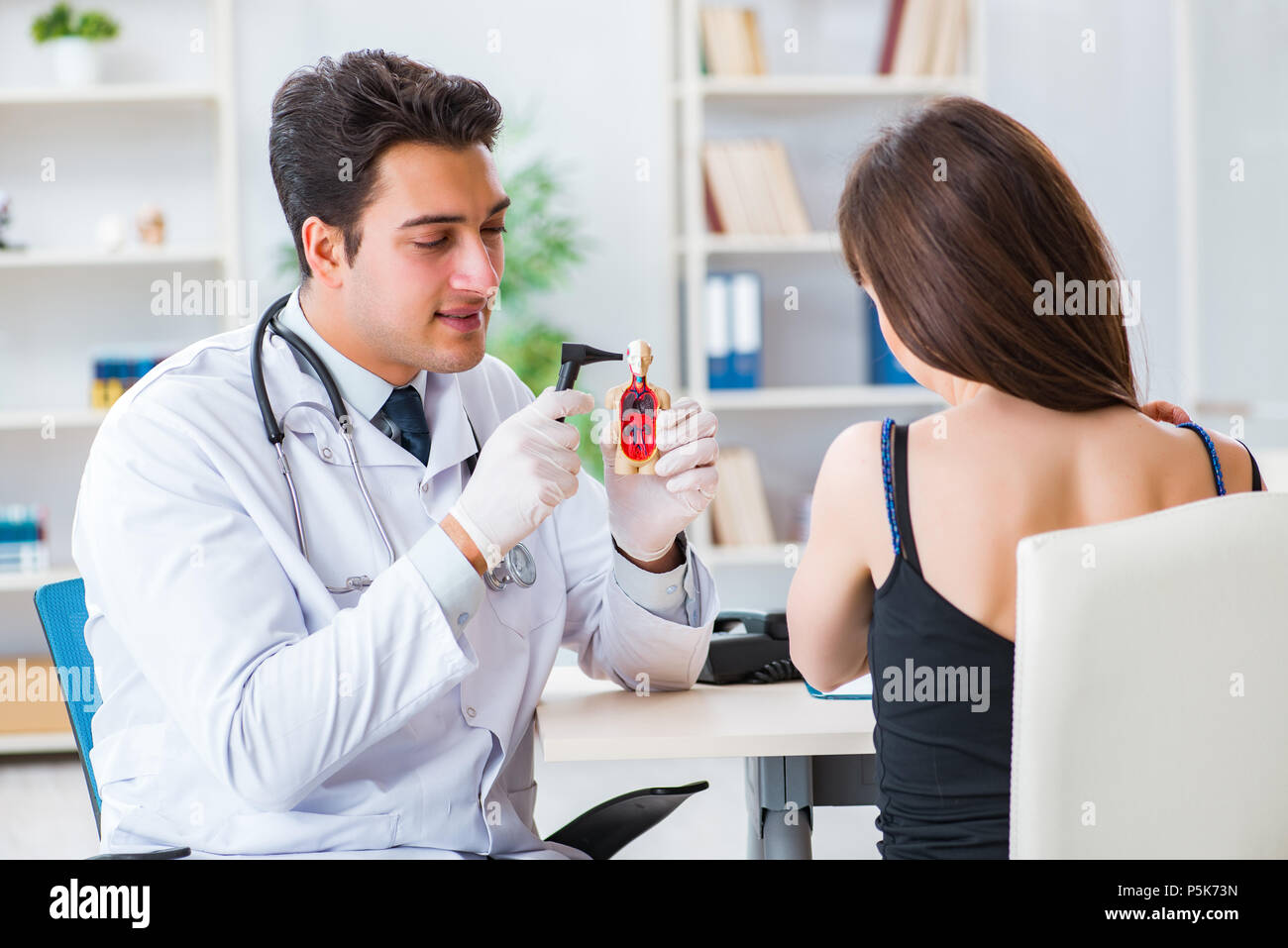 Doctor checking patients ear during medical examination Stock Photo - Alamy