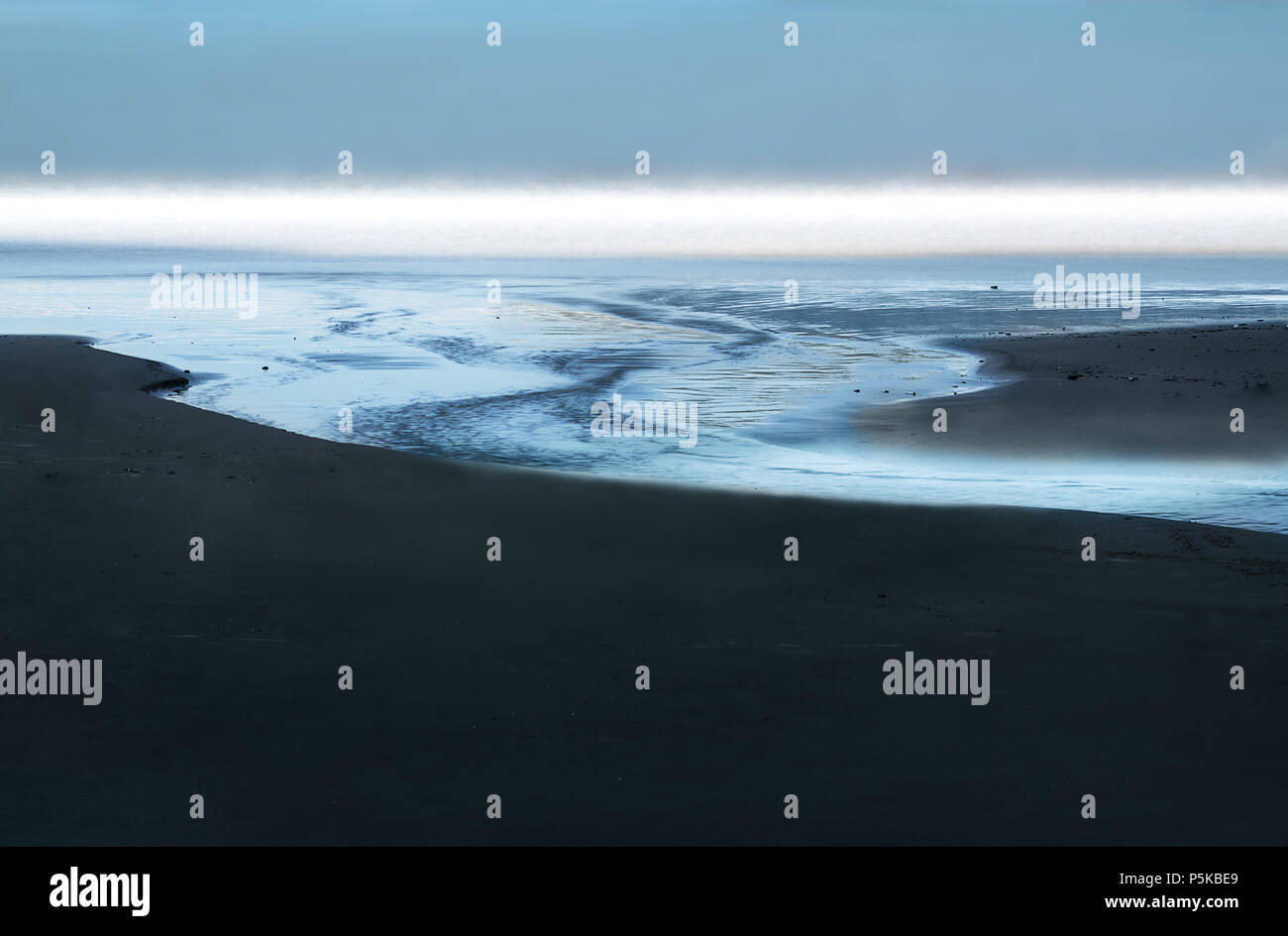 Abstract long exposure of a fresh water canal leading to the sea, with ...