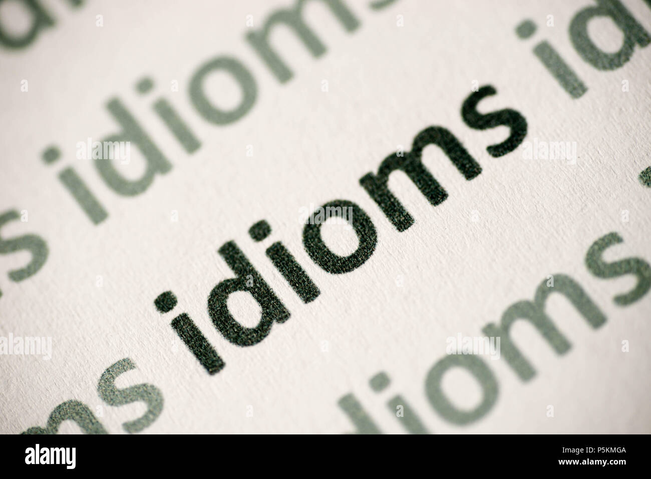 word idioms printed on white paper macro Stock Photo - Alamy