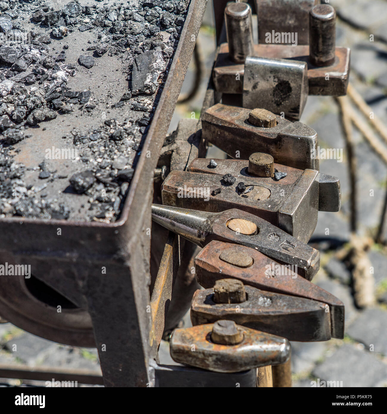 Historical tools of a blacksmith at a medieval market such as hammer ...