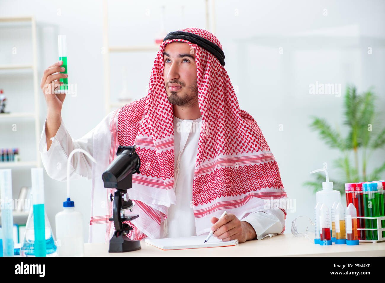 Arab chemist working in the lab office Stock Photo - Alamy