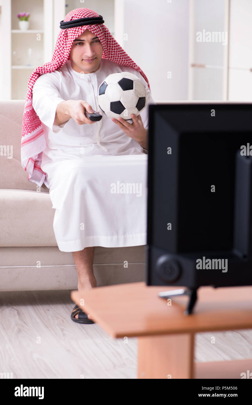 Arab man watching tv at home Stock Photo - Alamy