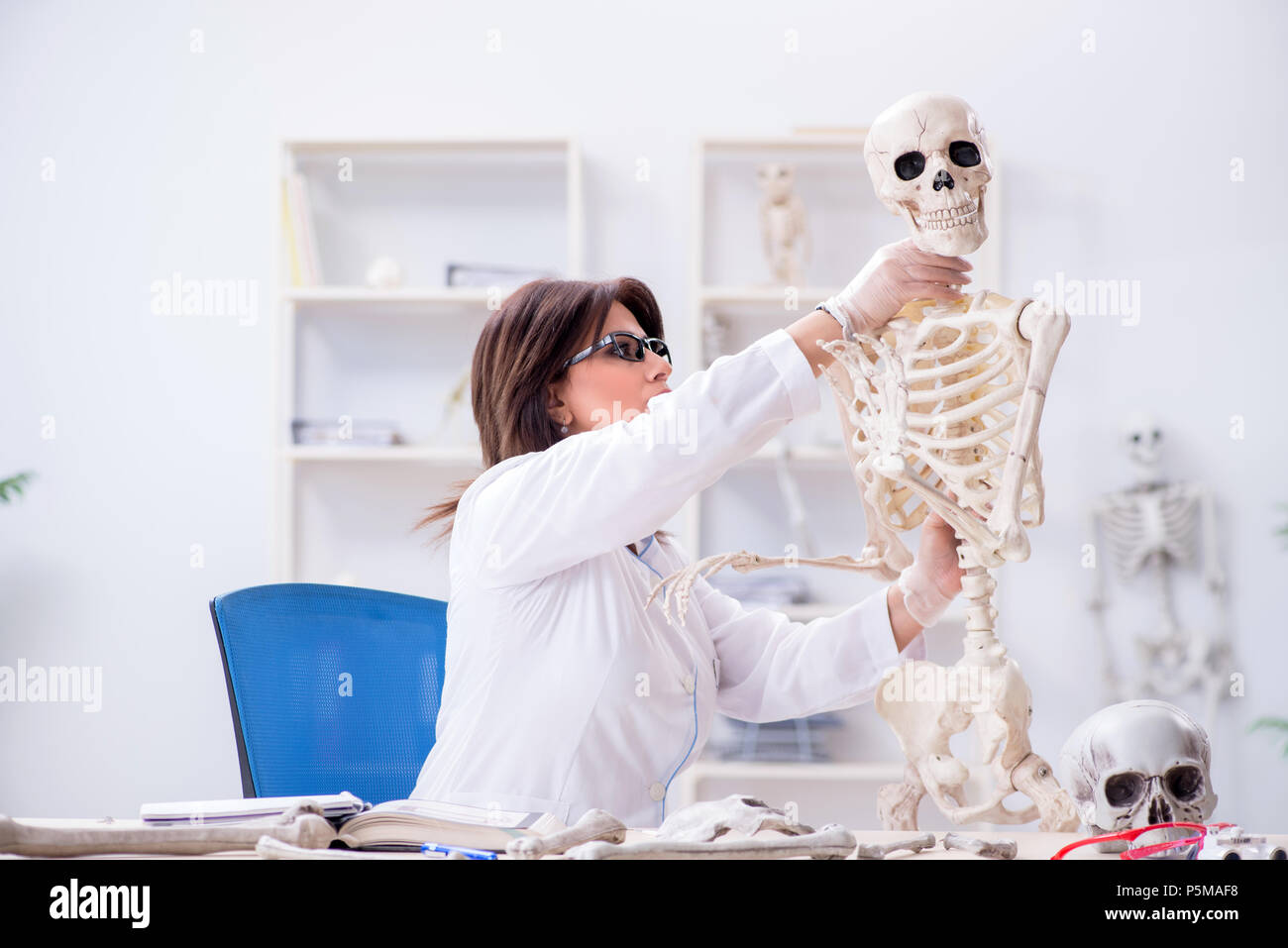 Doctor working in the lab on skeleton Stock Photo - Alamy