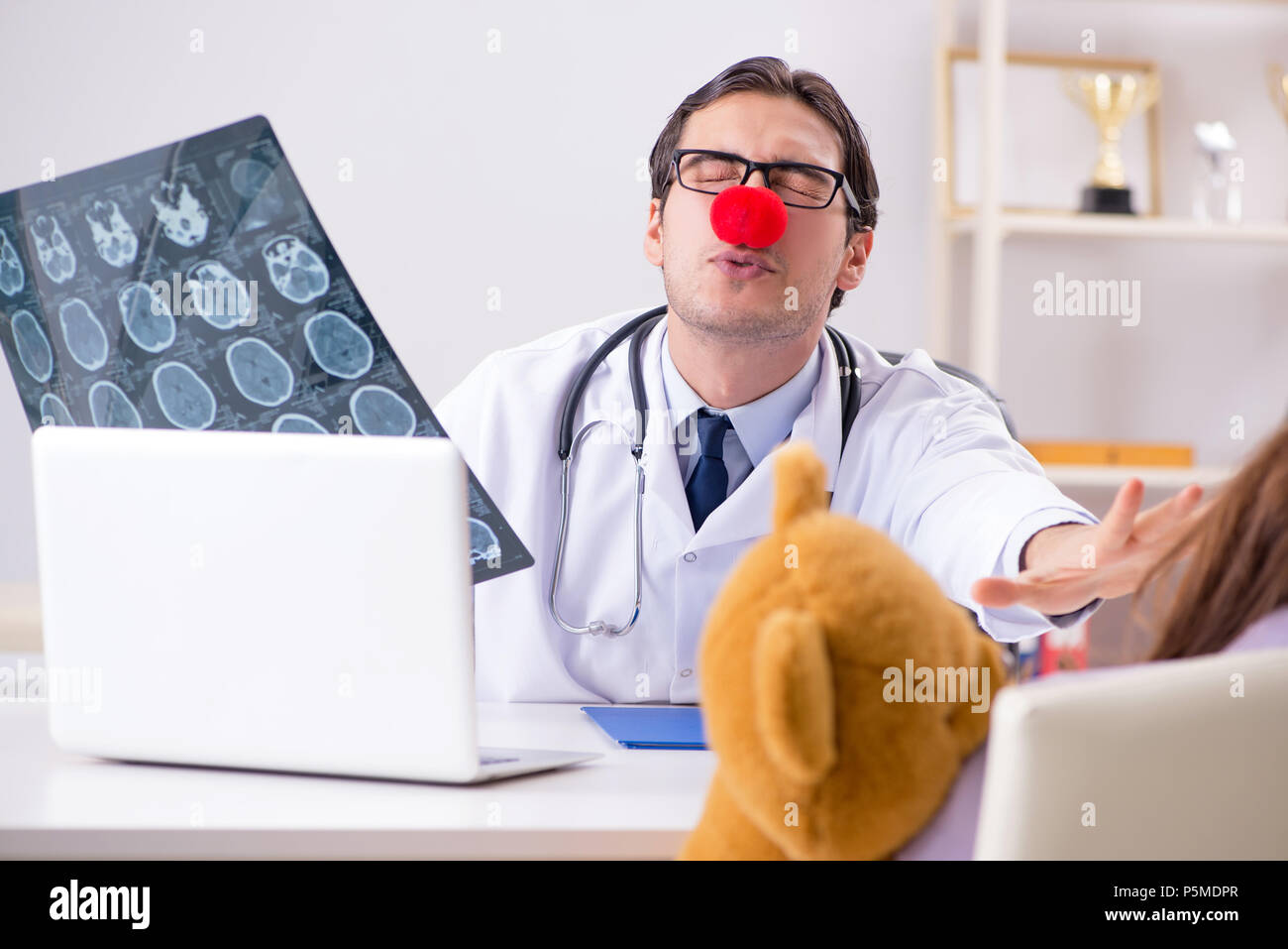 Funny pediatrician with little girl at regular check-up Stock Photo - Alamy