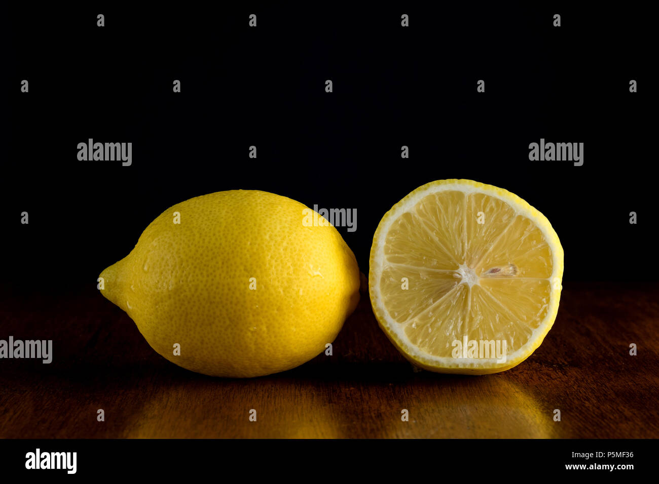 Lemon fruits on black background Stock Photo - Alamy