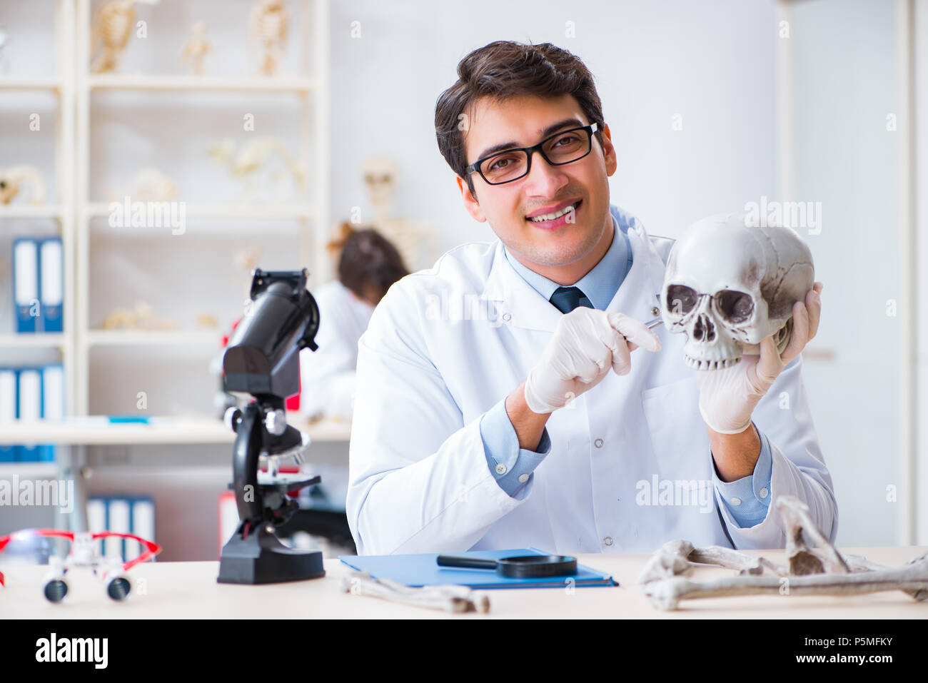 Professor studying human skeleton in lab Stock Photo - Alamy