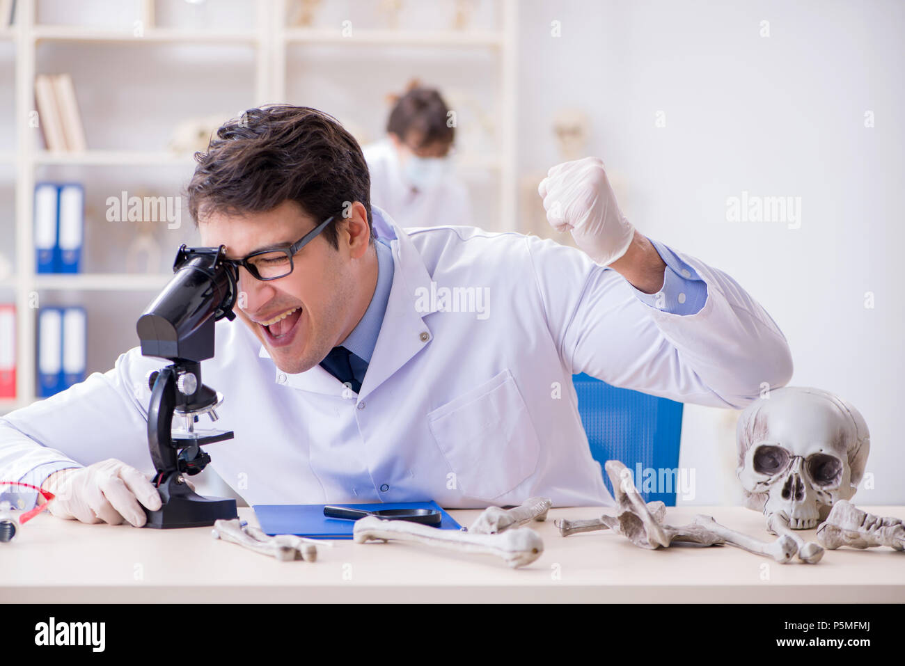 Professor studying human skeleton in lab Stock Photo - Alamy
