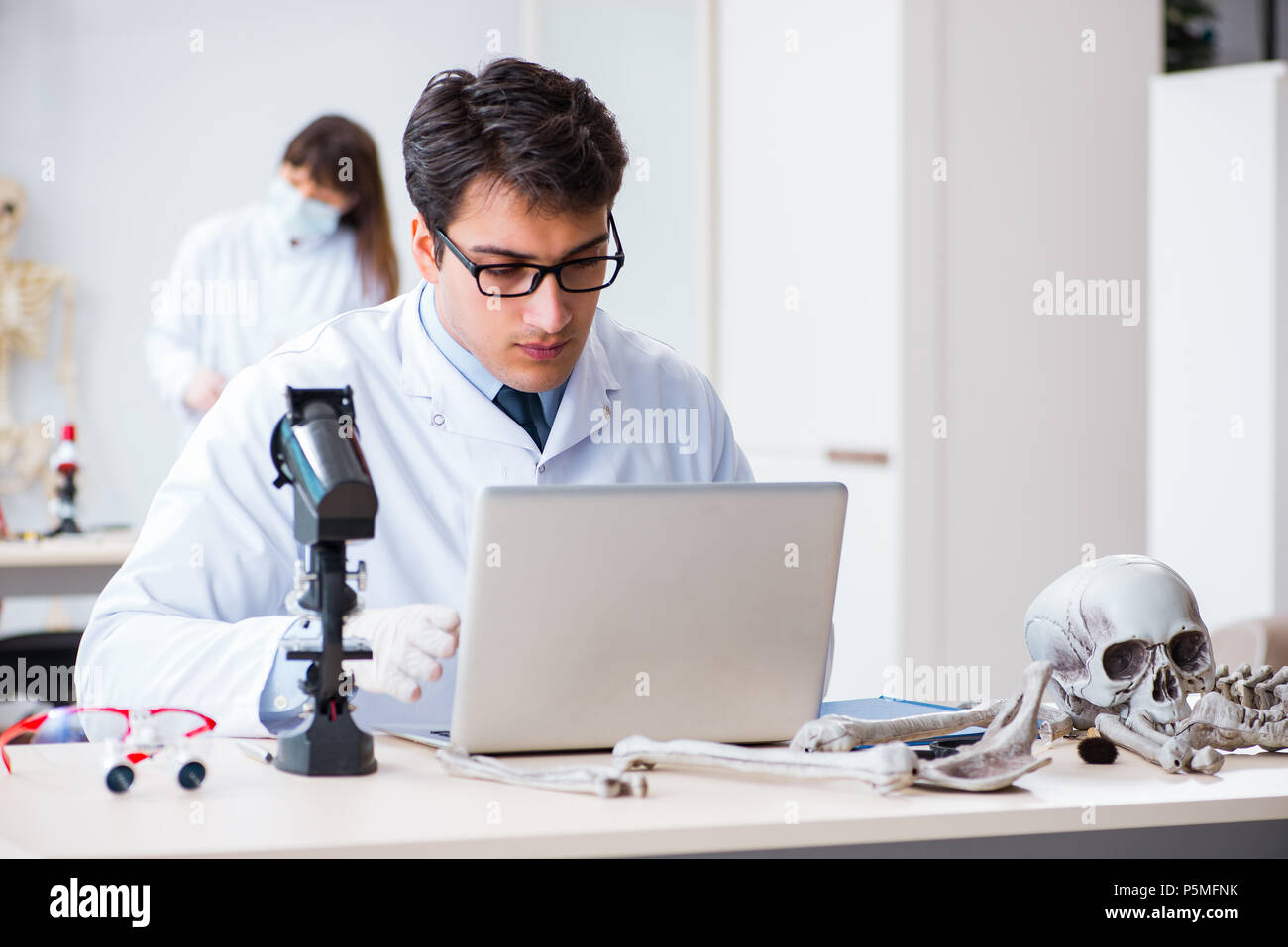 Professor studying human skeleton in lab Stock Photo - Alamy