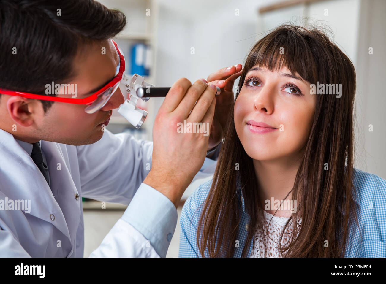 Doctor examining patients eye in hospital Stock Photo - Alamy