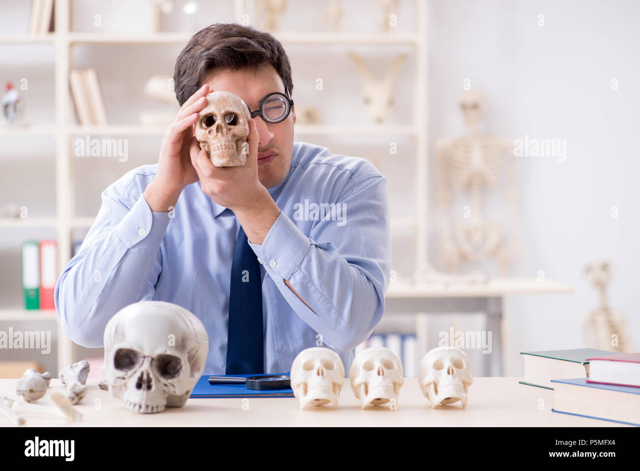 Funny crazy professor studying human skeleton Stock Photo - Alamy