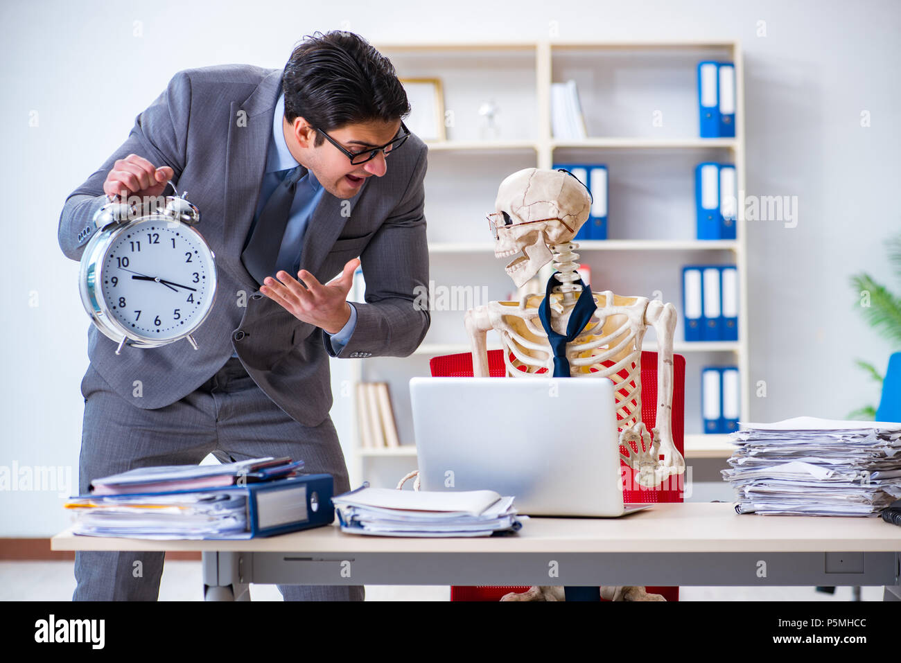 Angry boss yelling at his skeleton employee Stock Photo - Alamy