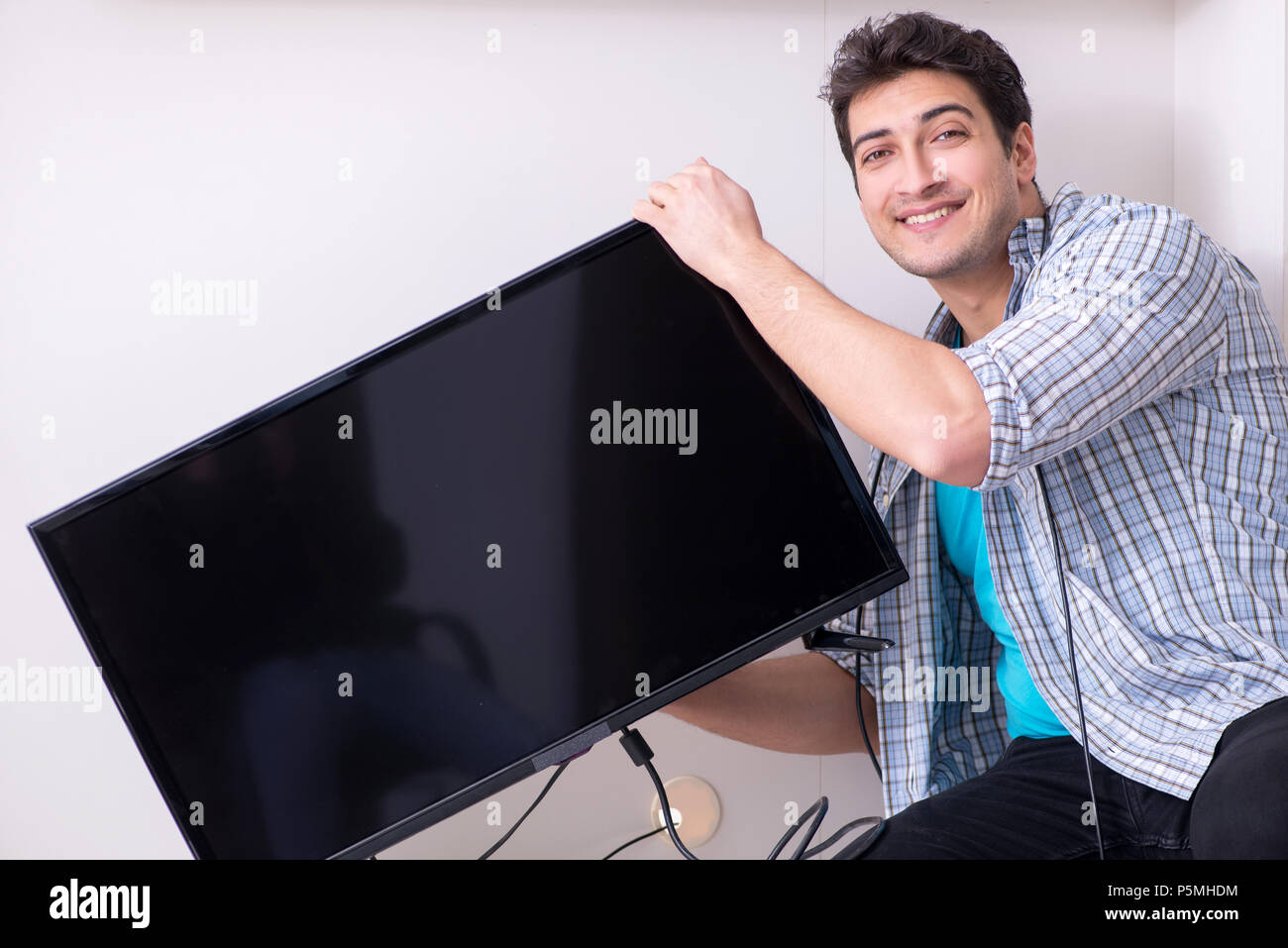 Man repairing broken tv at home Stock Photo - Alamy