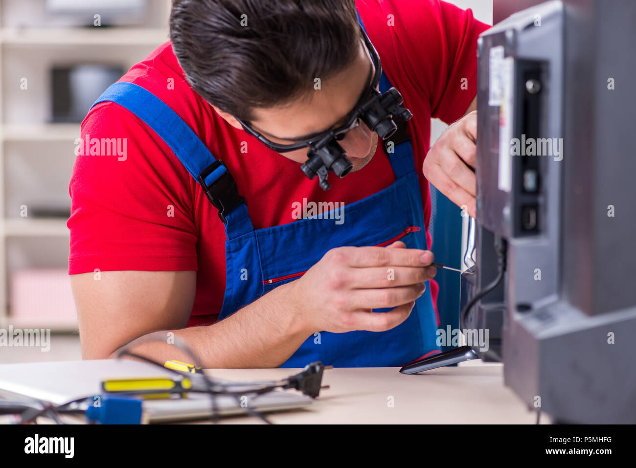 Professional repair engineer repairing broken tv Stock Photo - Alamy