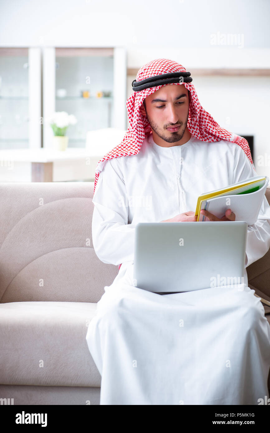Arab man working at home on his work Stock Photo - Alamy