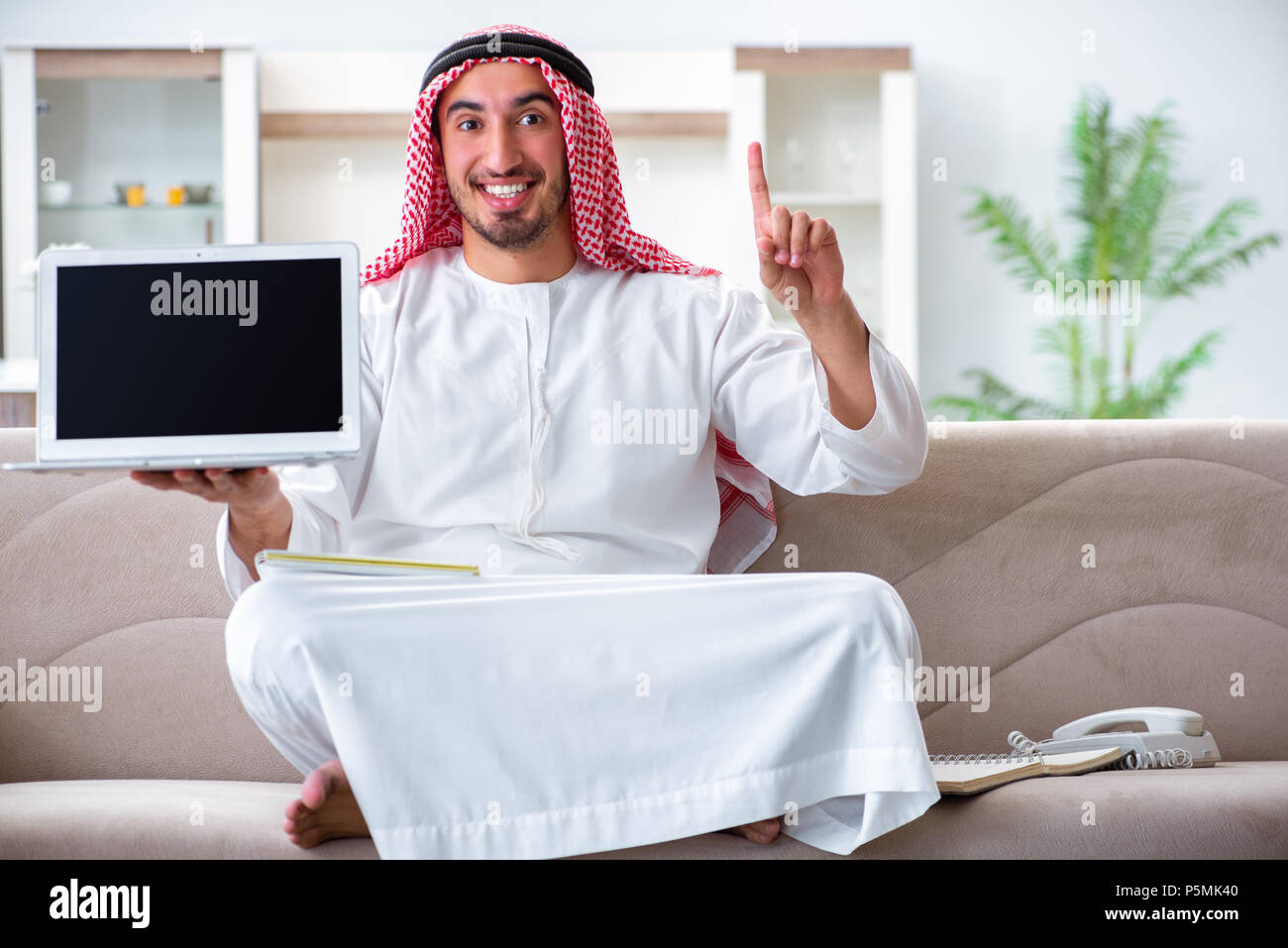 Arab man working at home on his work Stock Photo - Alamy