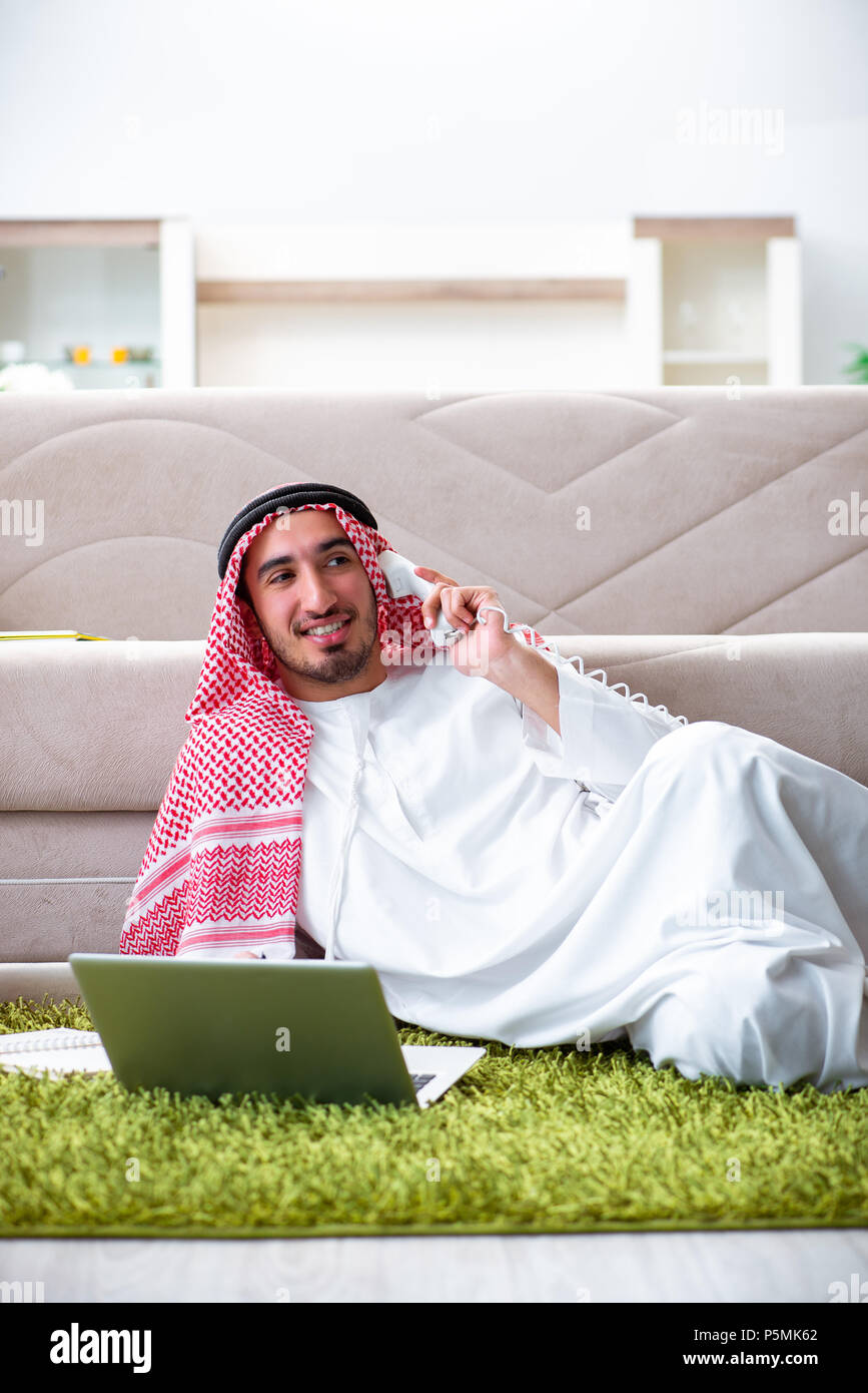 Arab man working at home on his work Stock Photo - Alamy