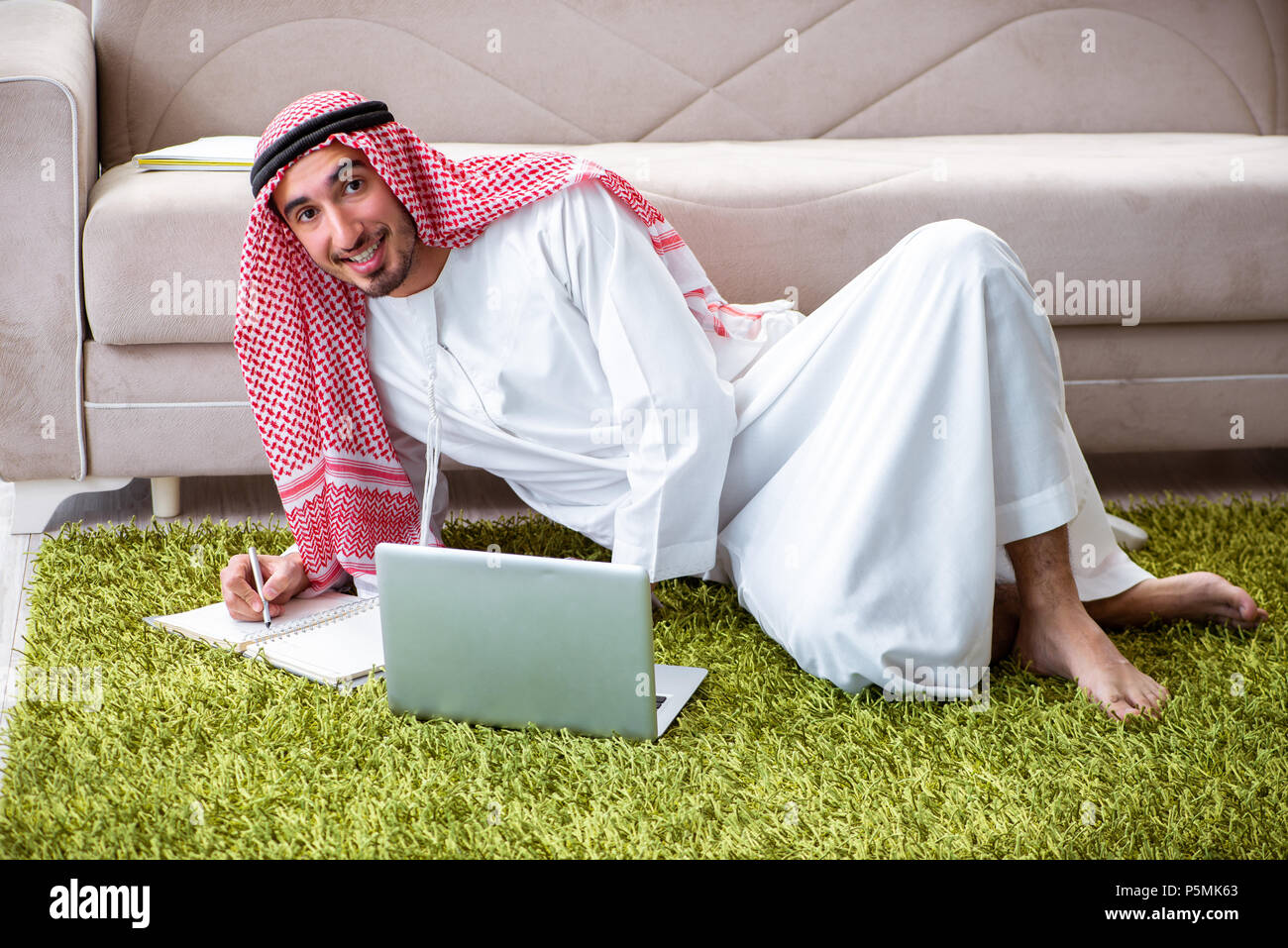 Arab man working at home on his work Stock Photo - Alamy