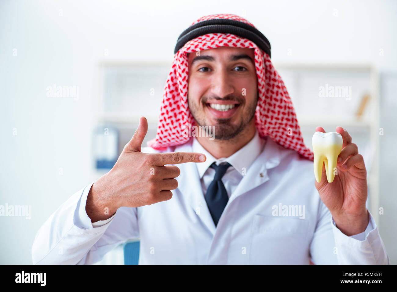 Arab dentist working on new teeth implant Stock Photo - Alamy