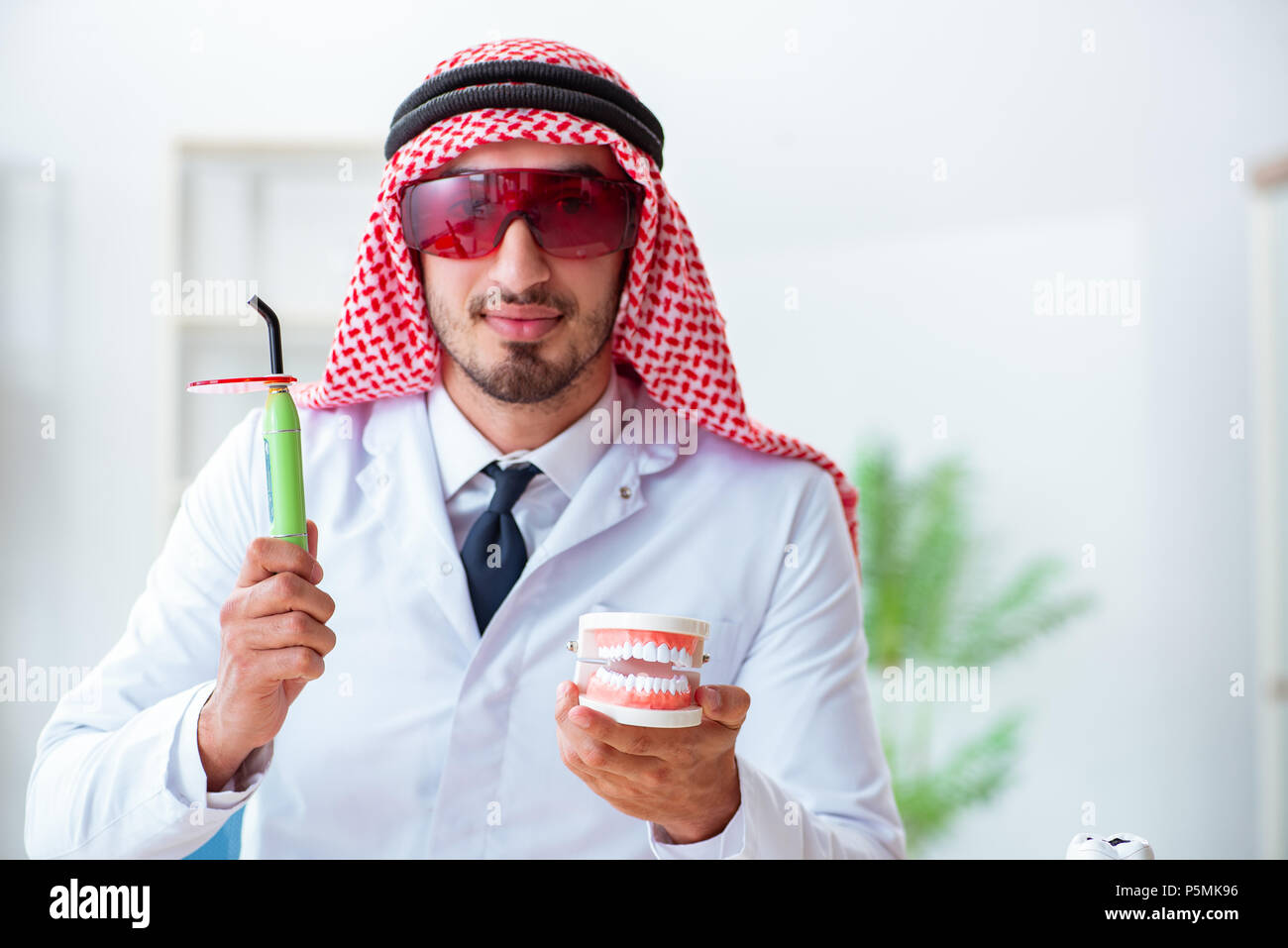 Arab dentist working on new teeth implant Stock Photo - Alamy