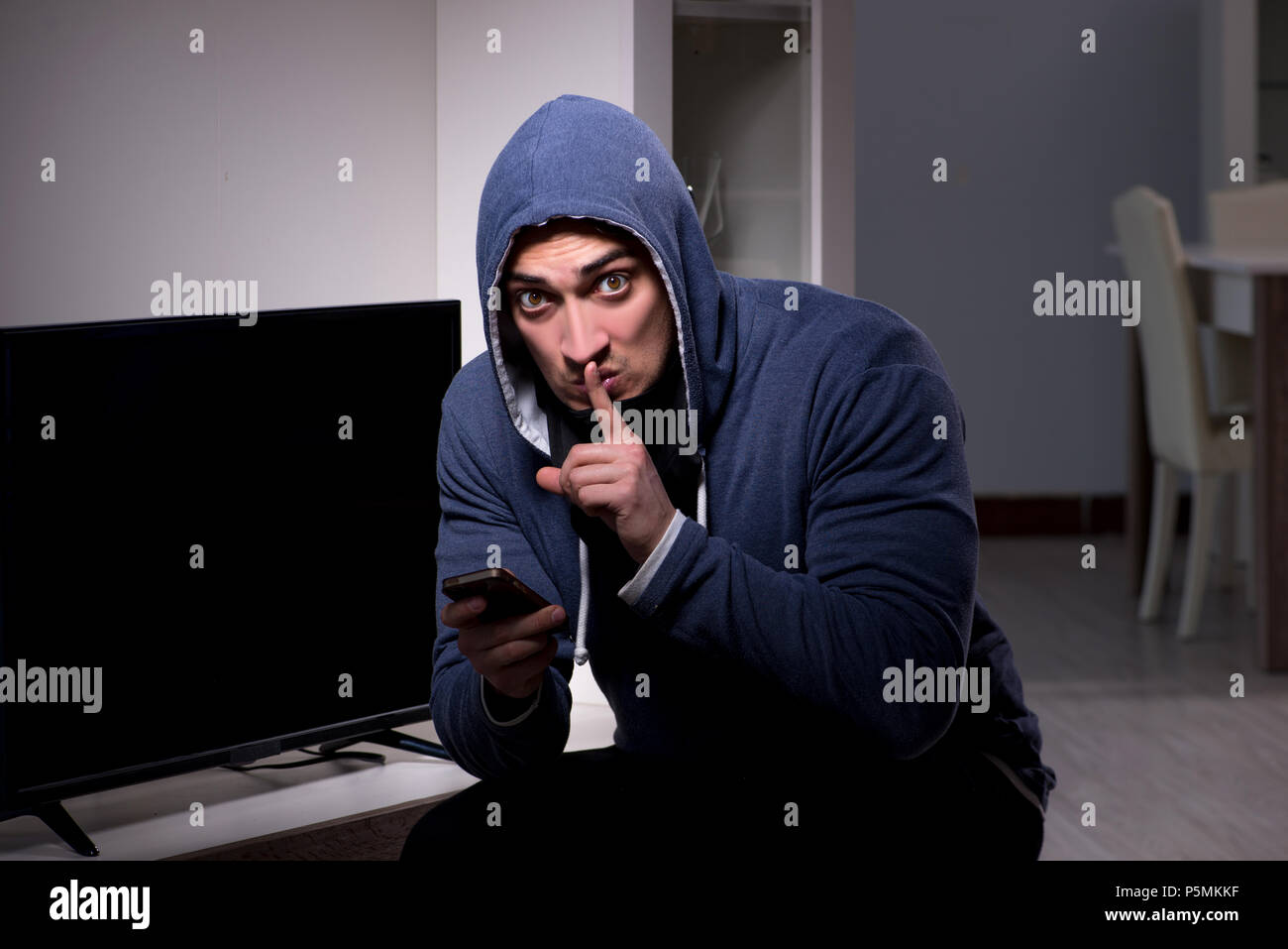 Burglar thief stealing tv from apartment house Stock Photo - Alamy