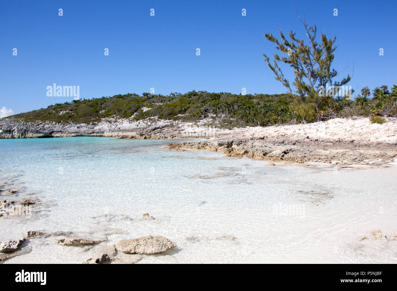 Crystal clear waters of a rocky beach on uninhabited island Half Moon ...