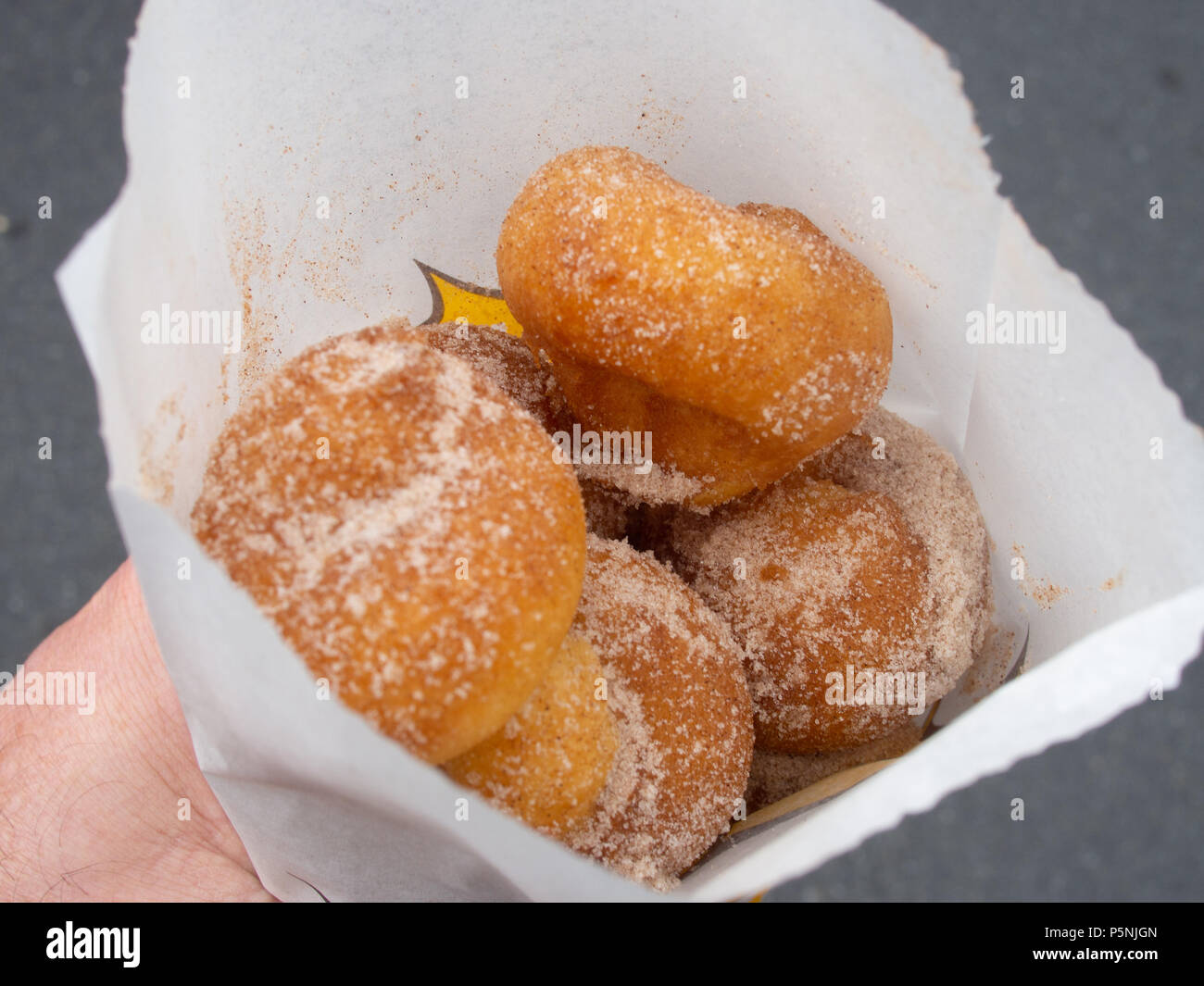 Holding A Bag Of Sugar Covered Mini Donuts Stock Photo - Alamy